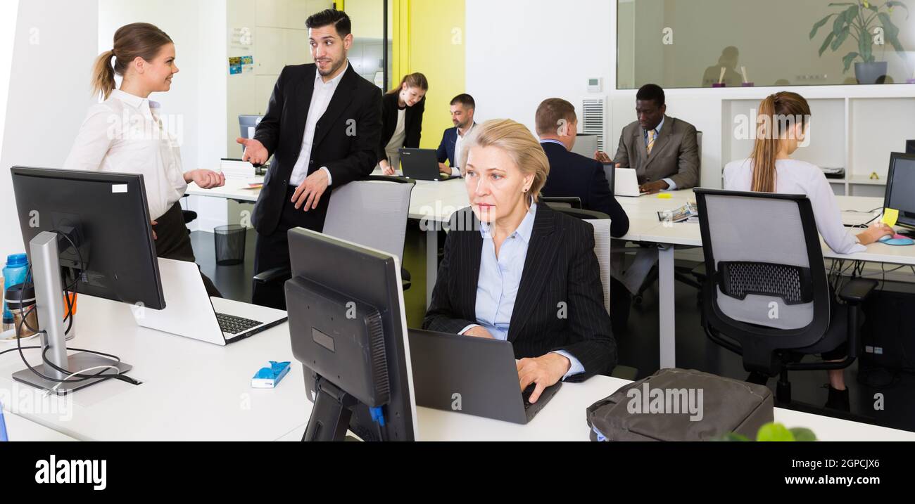 Business people working in open plan office Stock Photo - Alamy