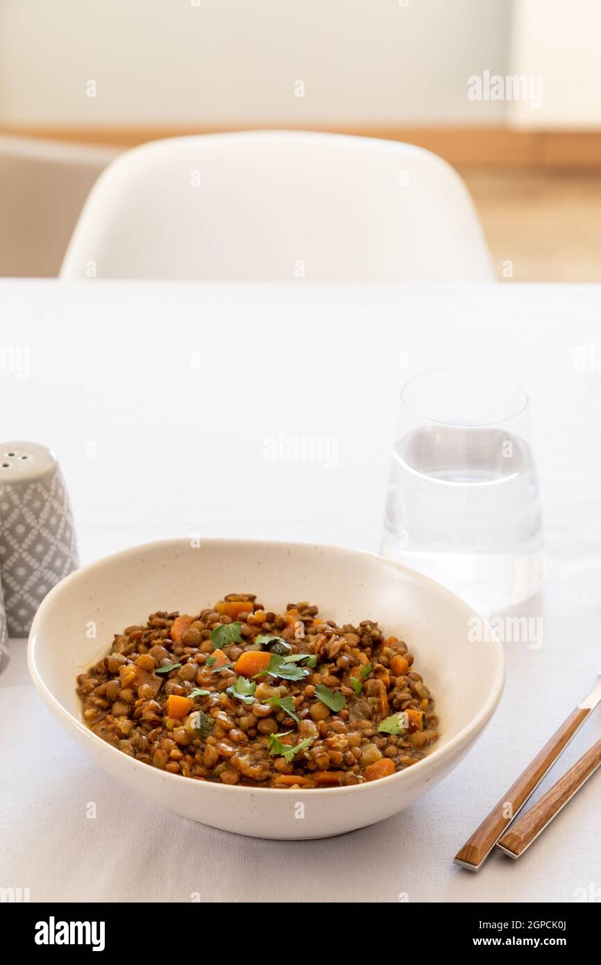lentils with vegetables in a plate on the dining table. comfort ...