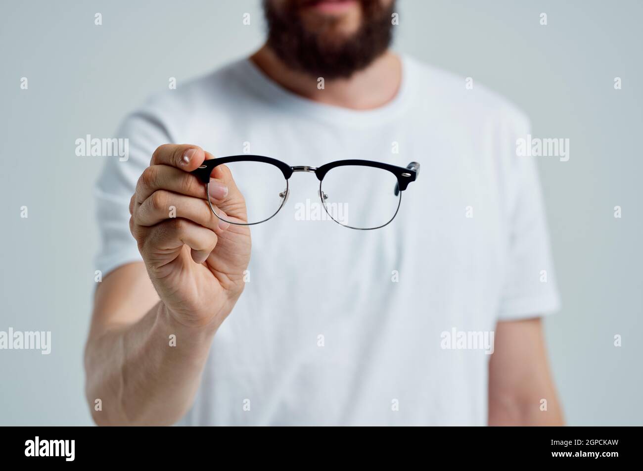 man with glasses in hand vision problems light background Stock Photo ...