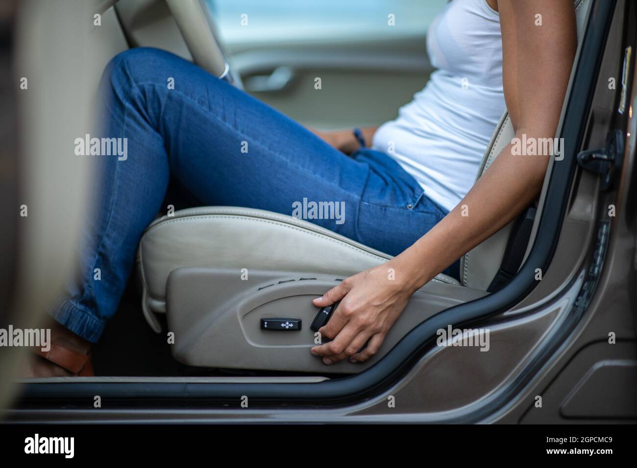 Young female driver driving her car at night (color toned image ...