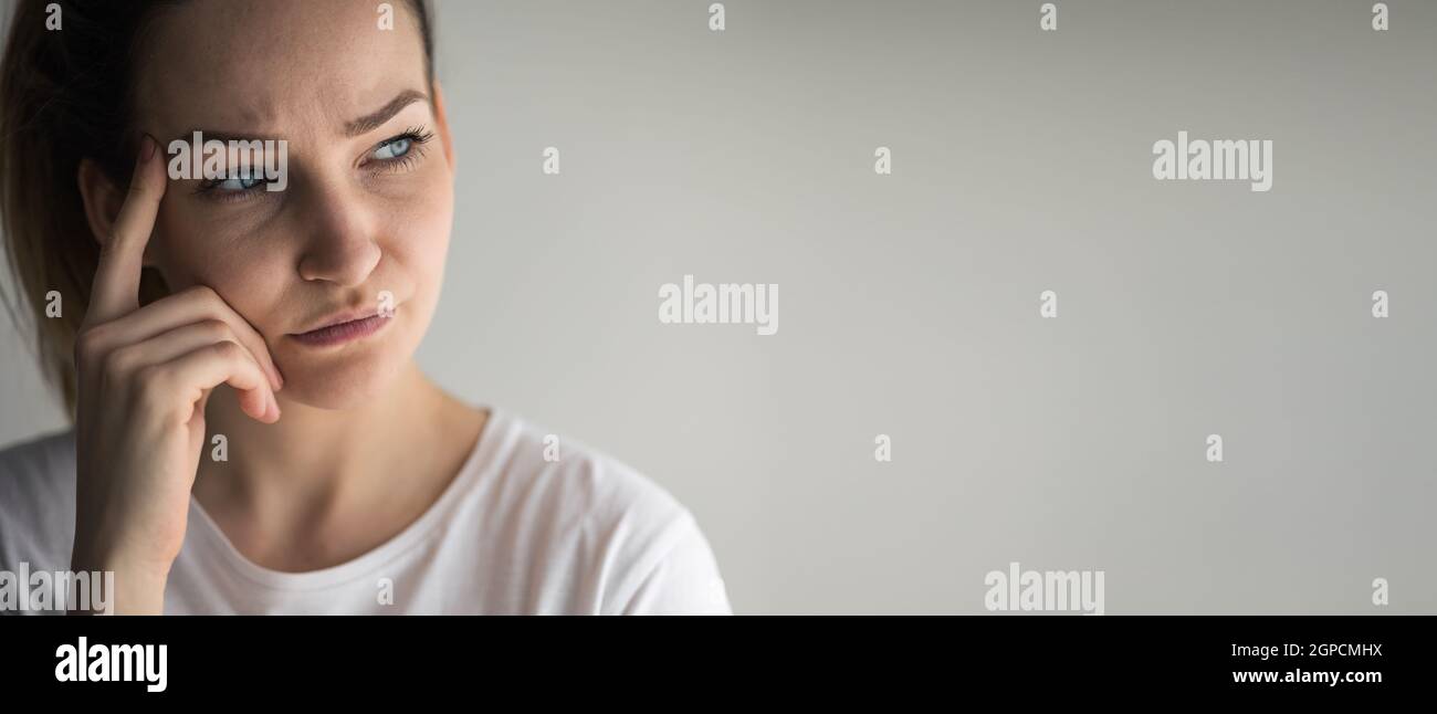 Anxious, worried, stressed young woman looking pensive, pondering, deep ...