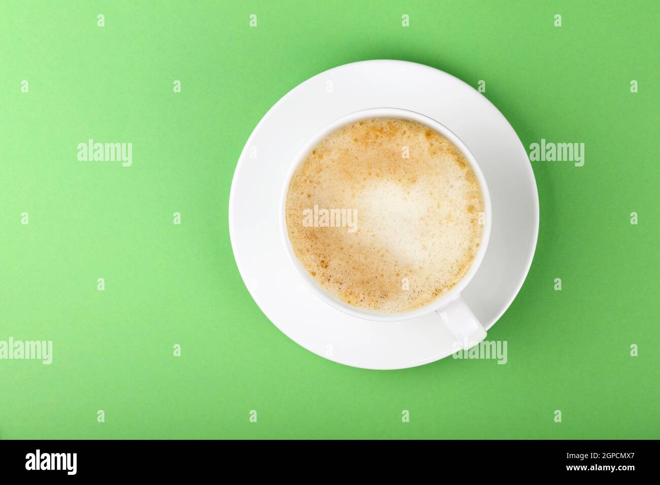 Close up one full white cup of frothy latte cappuccino coffee and ...