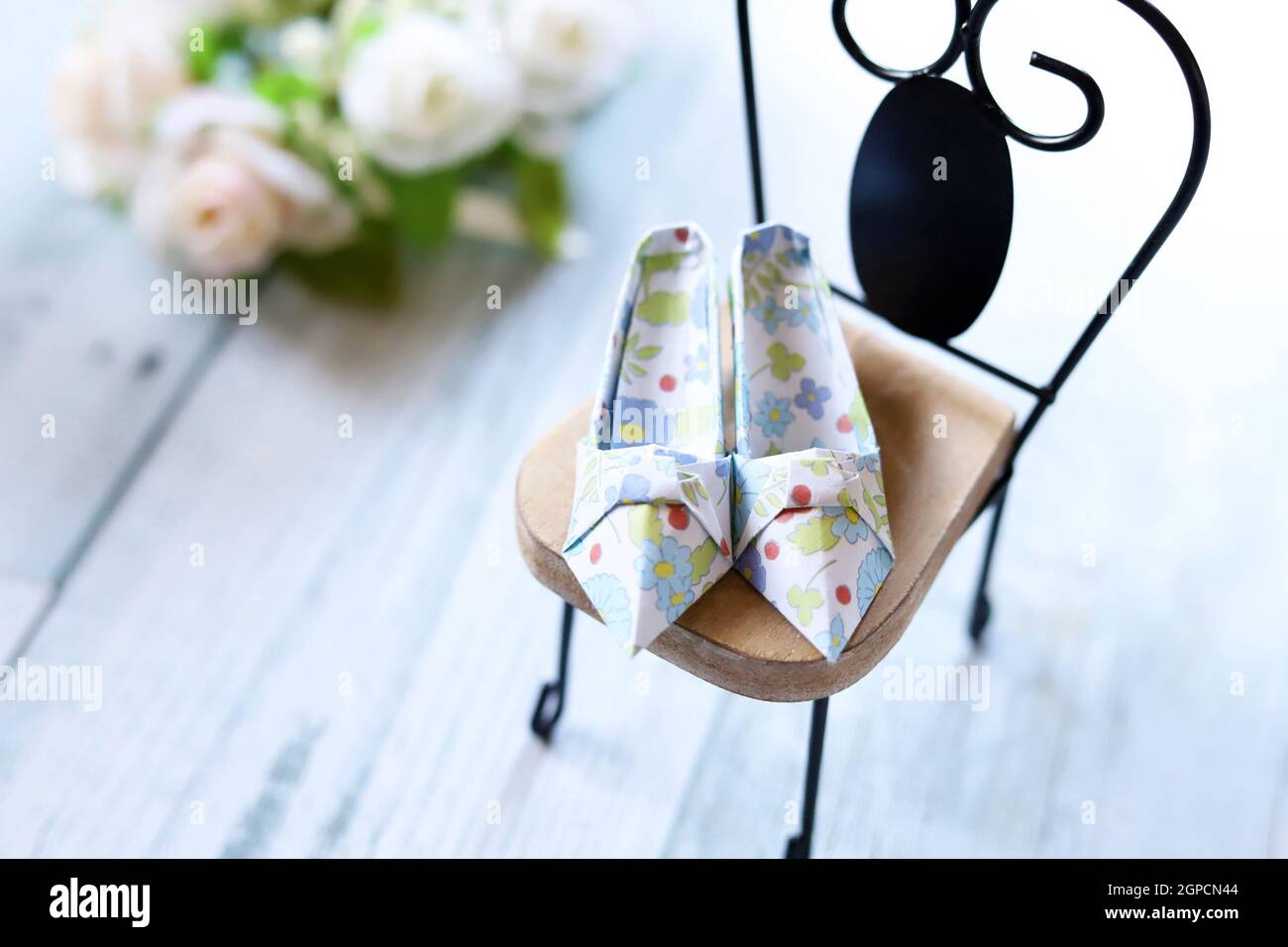 Handmade origami high heels on a miniature chair Stock Photo - Alamy