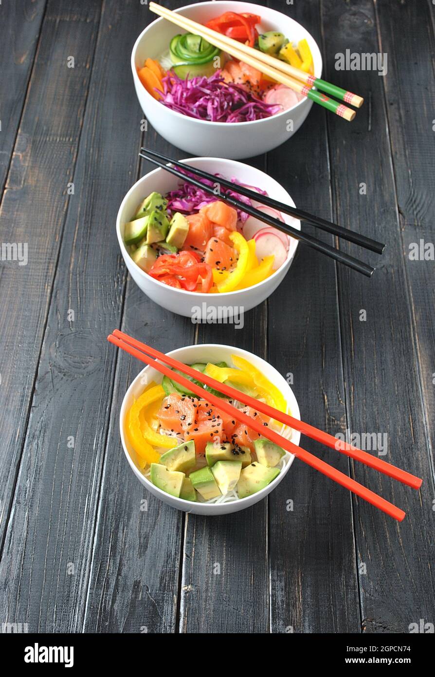 Poke bowls with fresh salmon, crystal noodles, radish, avocado, sweet ...