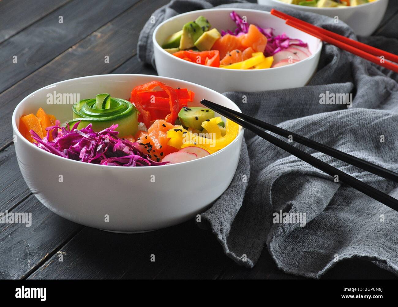 Poke bowls with fresh salmon, crystal noodles, radish, avocado, sweet ...