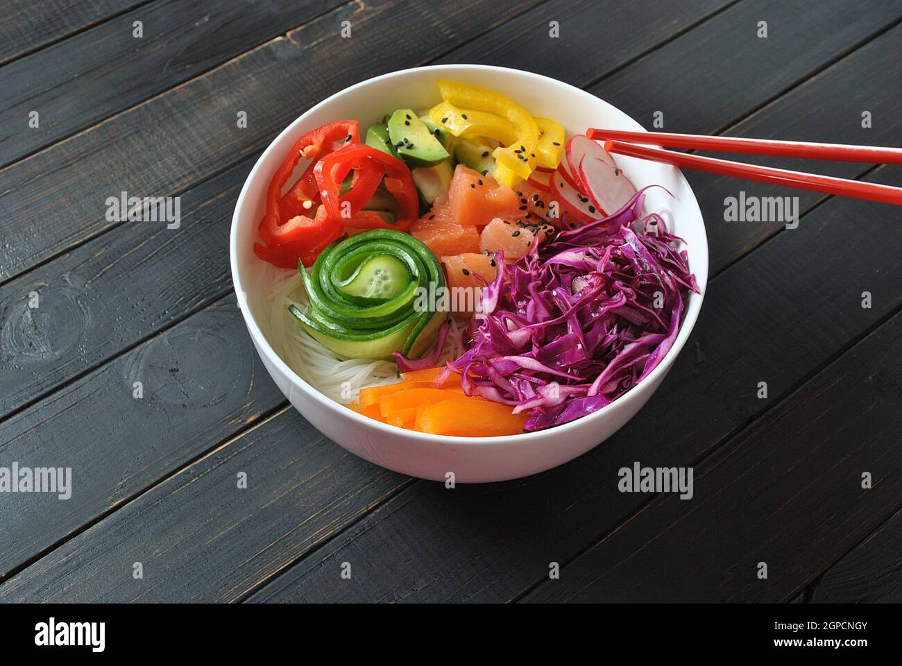 Poke bowls with fresh salmon, crystal noodles, radish, avocado, sweet ...