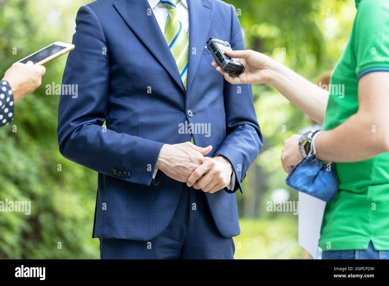 Journalist holding voice recorder making media interview with ...