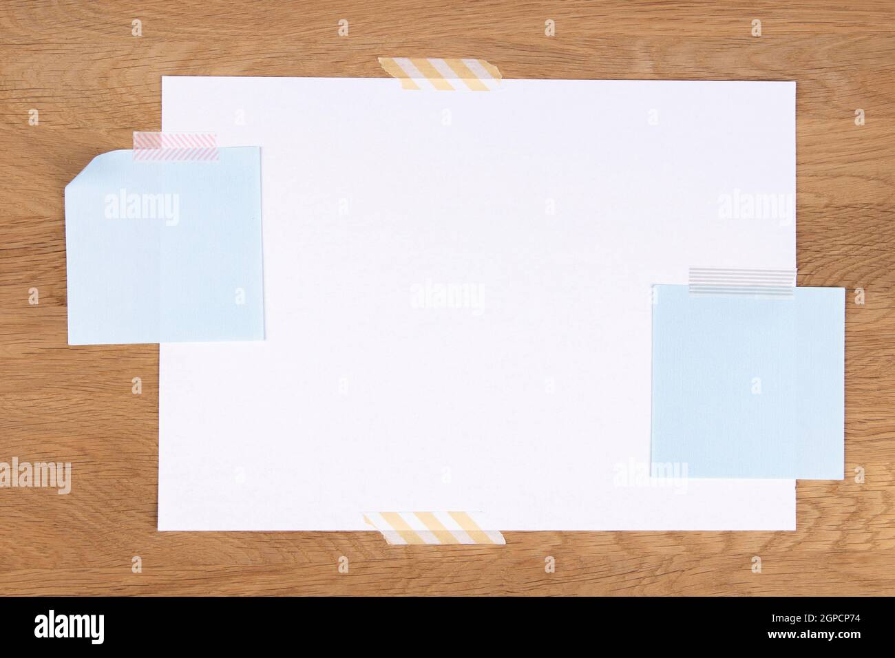 Blank white paper page and note sticks attached with adhesive tape on ...