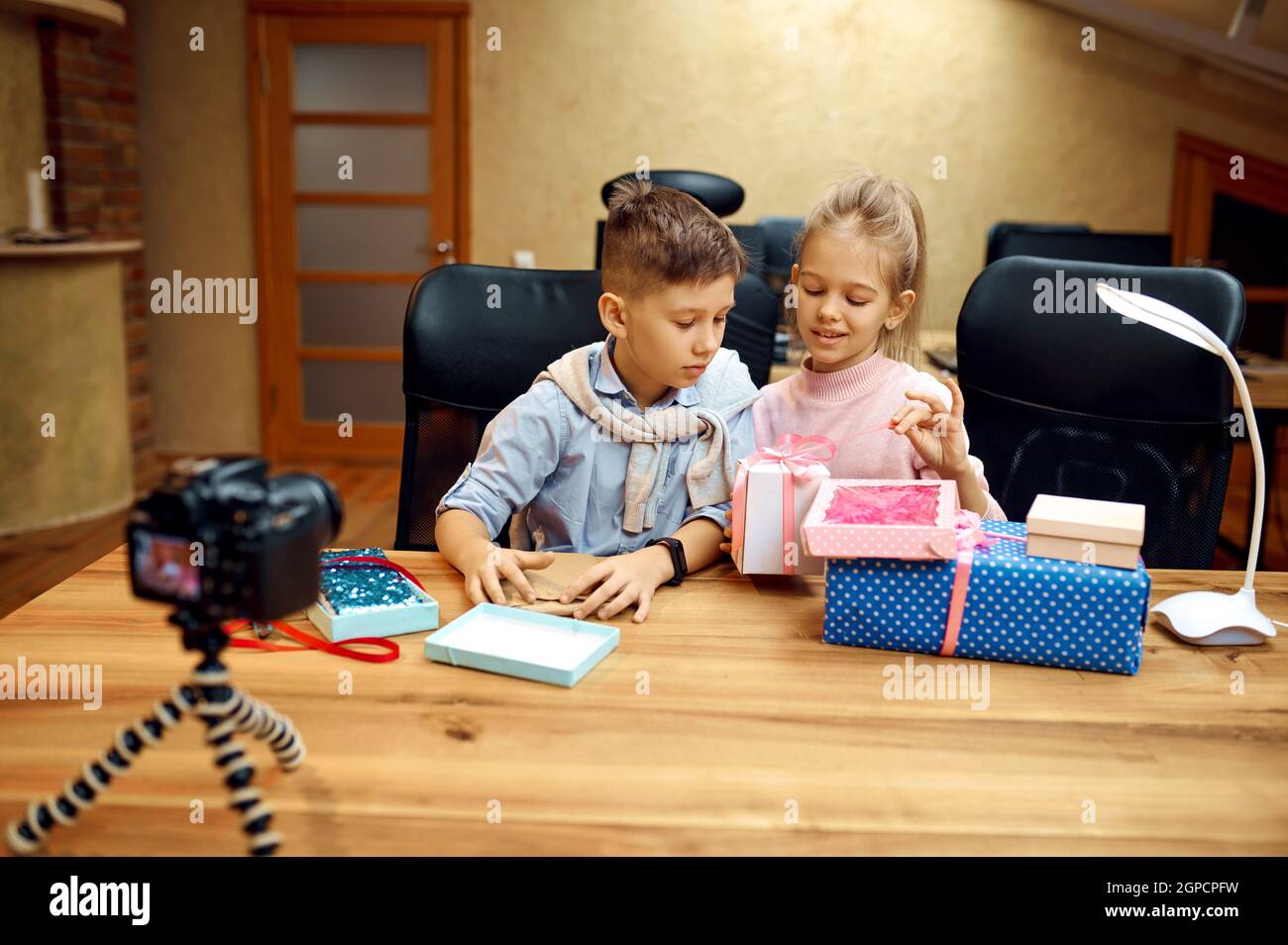 Children bloggers poses on camera, little bloggers. Kids blogging in ...