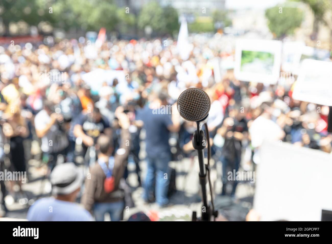 Public demonstration or political protest. Microphone in focus against ...