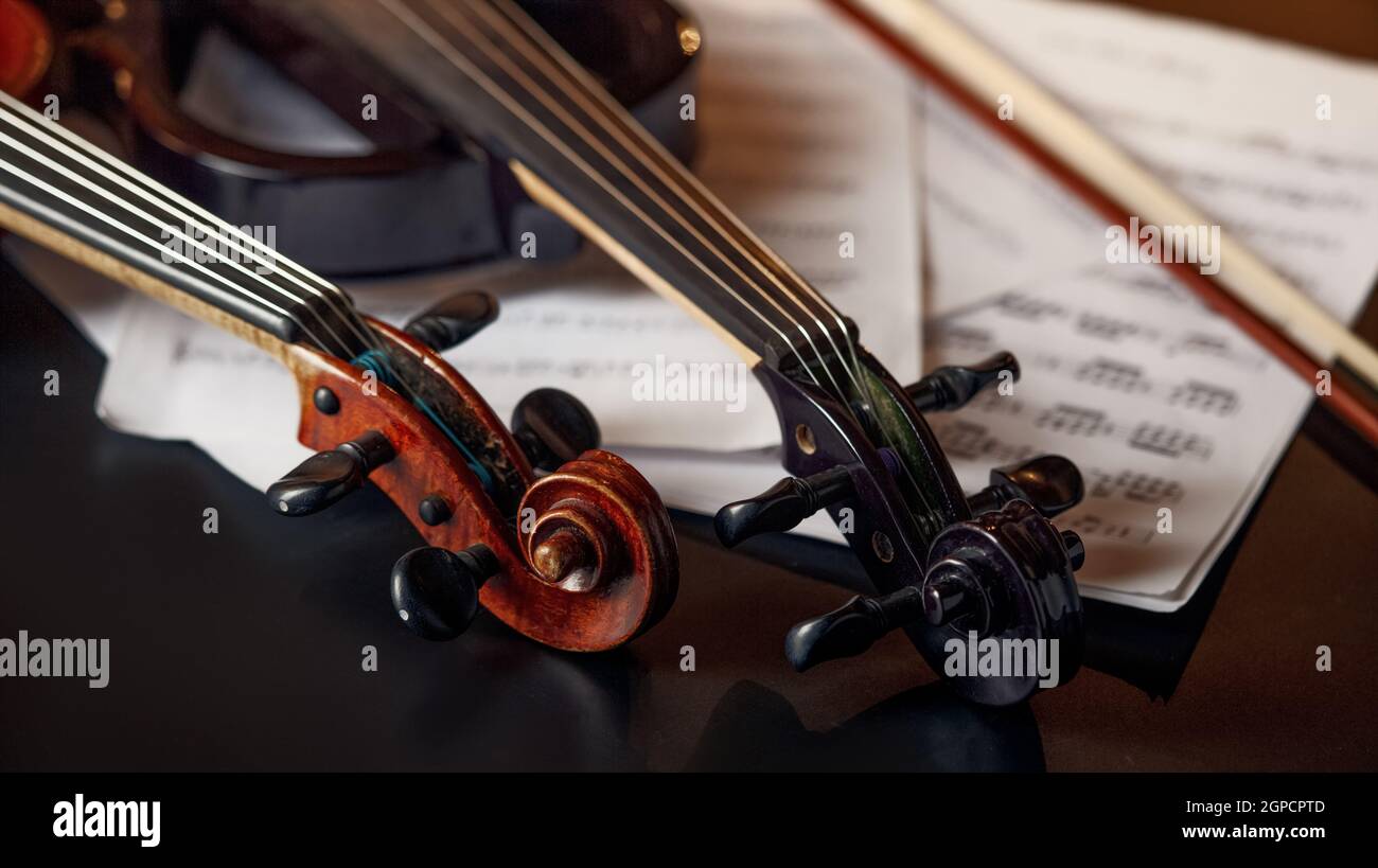 Retro violin and modern electric viola, closeup view, nobody. Two classical string musical ...