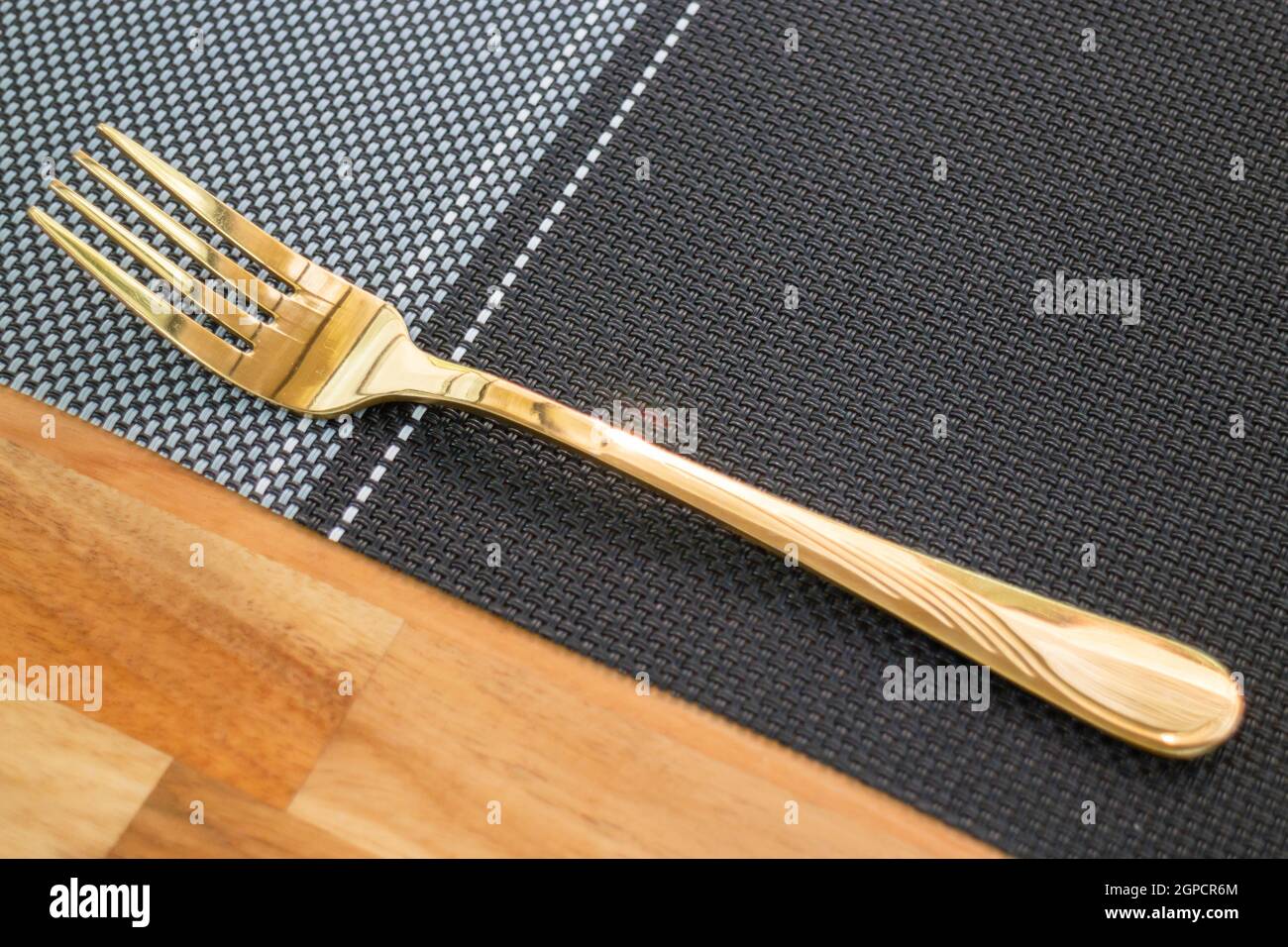 Golden metal fork on dining table, stock photo Stock Photo - Alamy