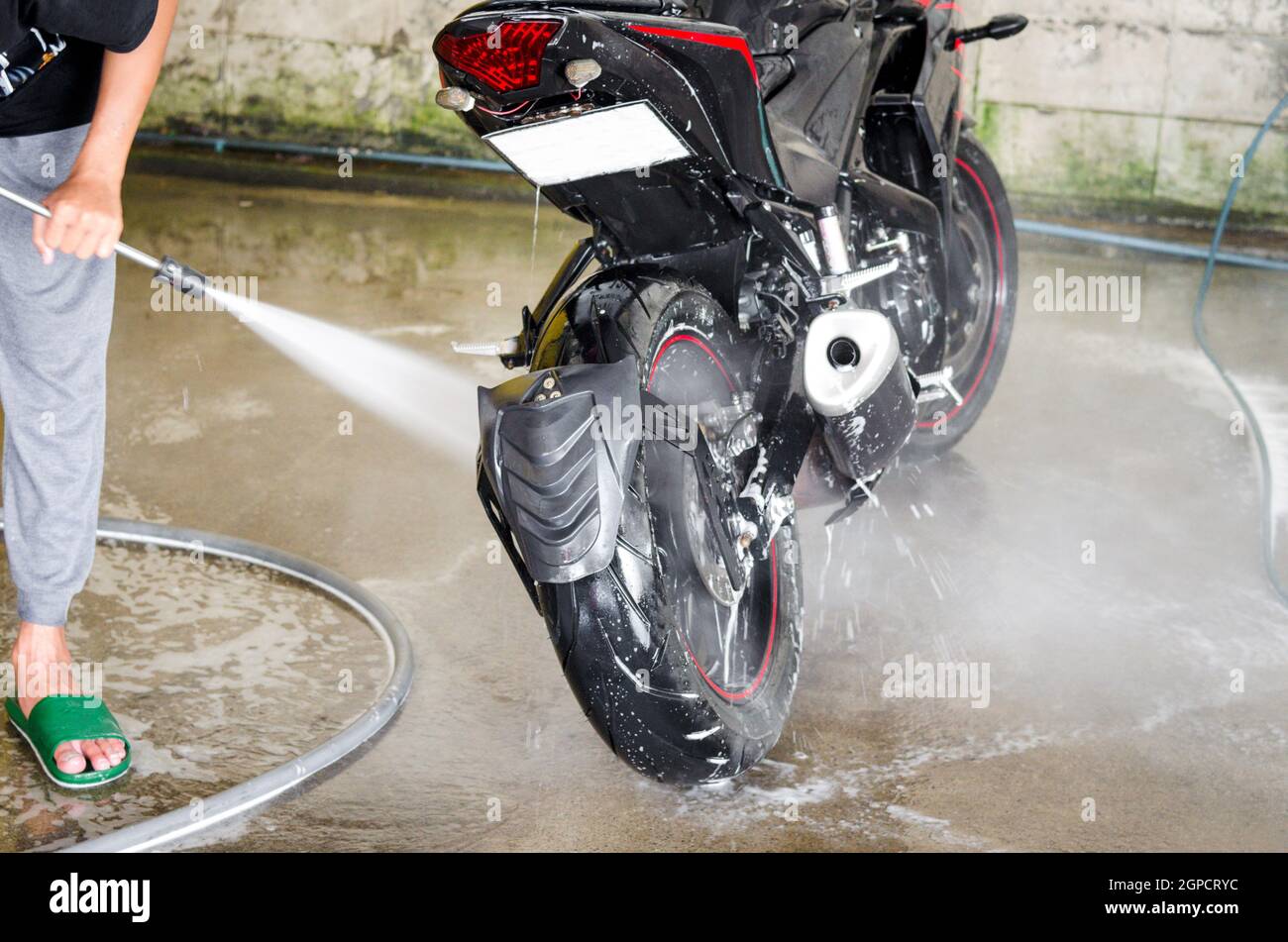 Clean up the motorcycle wash at the car wash shop Stock Photo - Alamy