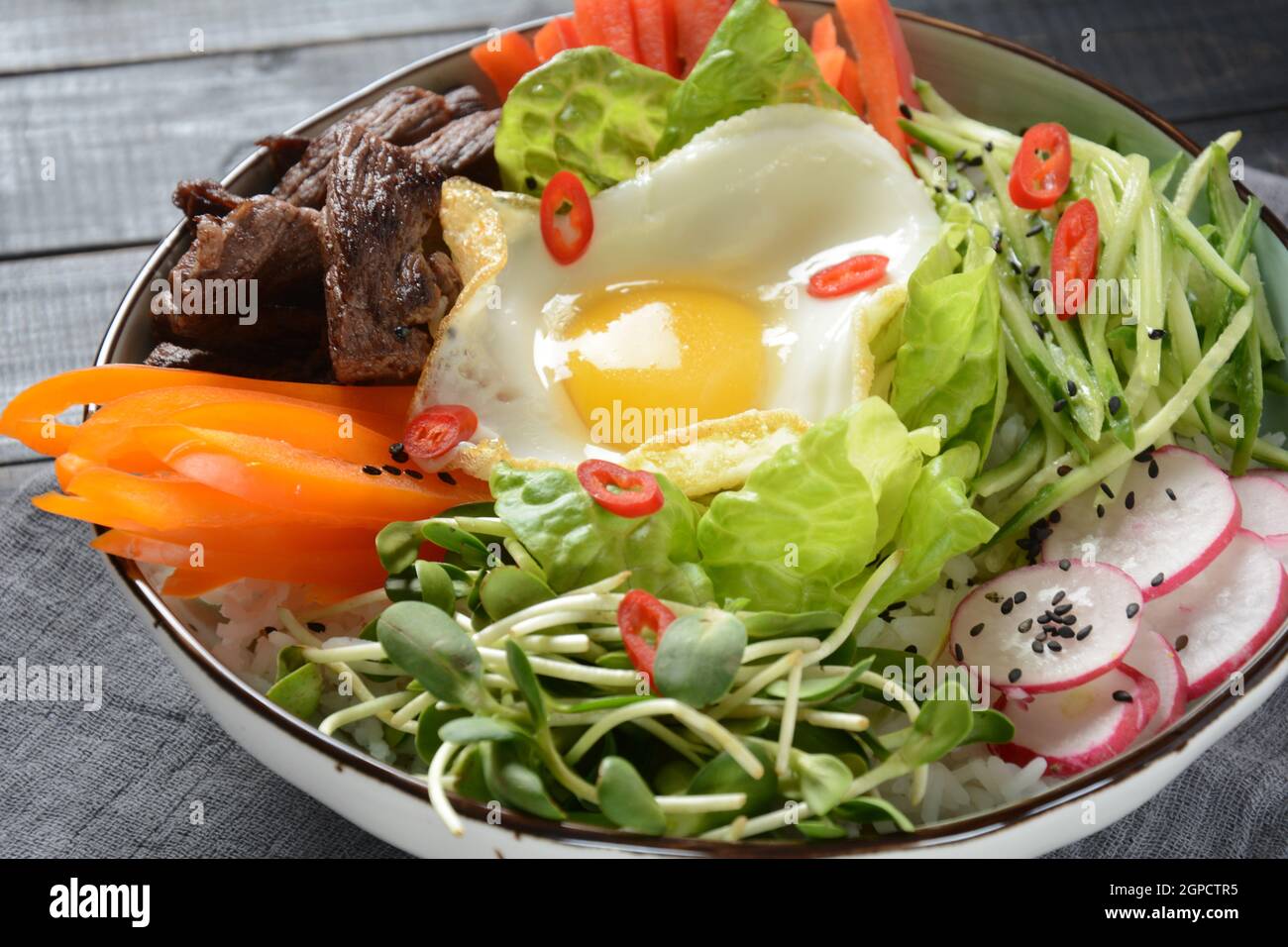 Traditional Korean dish- Bibimbap, rice with egg, beef and vegetables ...