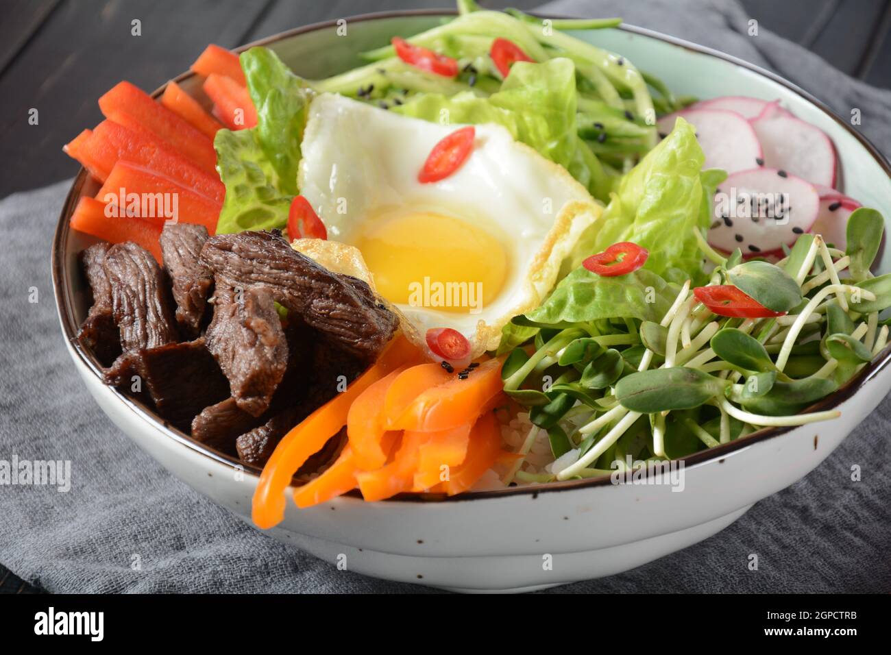 Traditional Korean dish- Bibimbap, rice with egg, beef and vegetables ...