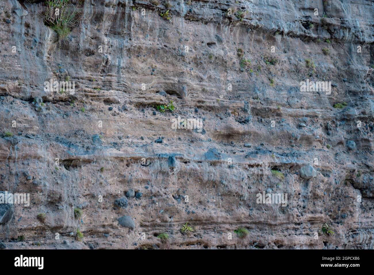 Natural background. Closeup edged shabby cliff cracks. Gray-brown stone ...