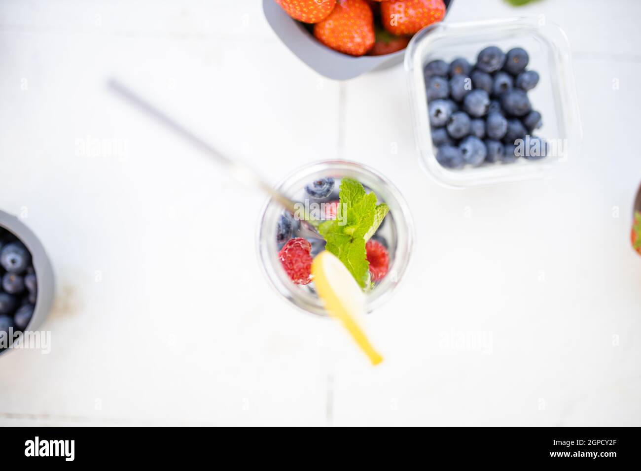Lemon slice on edge of jar with fruity beverage inside. Beverage ...