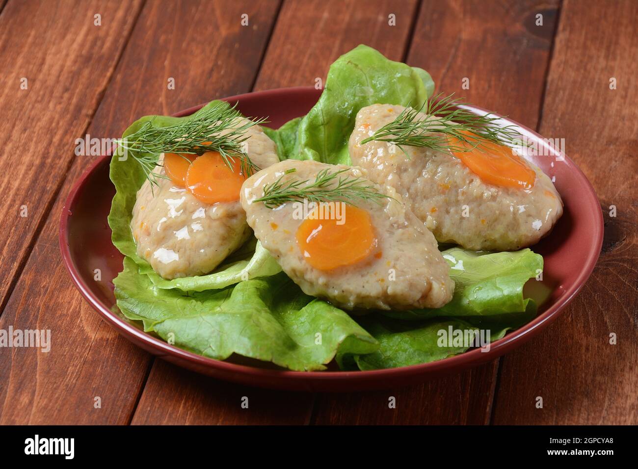 Traditional Jewish Passover food- gefilte fish with carrots, lettuce ...