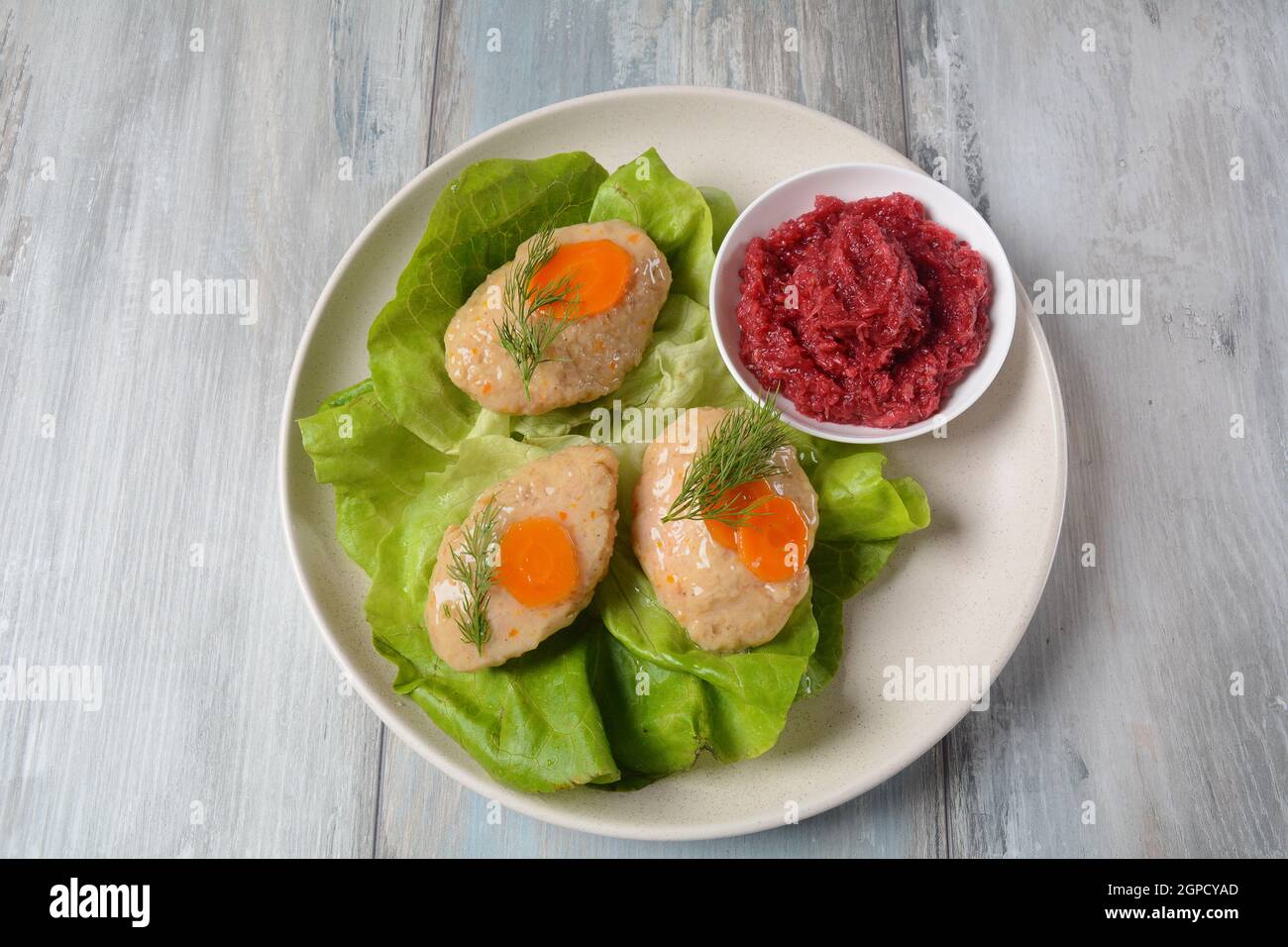 Traditional Jewish Passover food- gefilte fish with carrots, lettuce ...