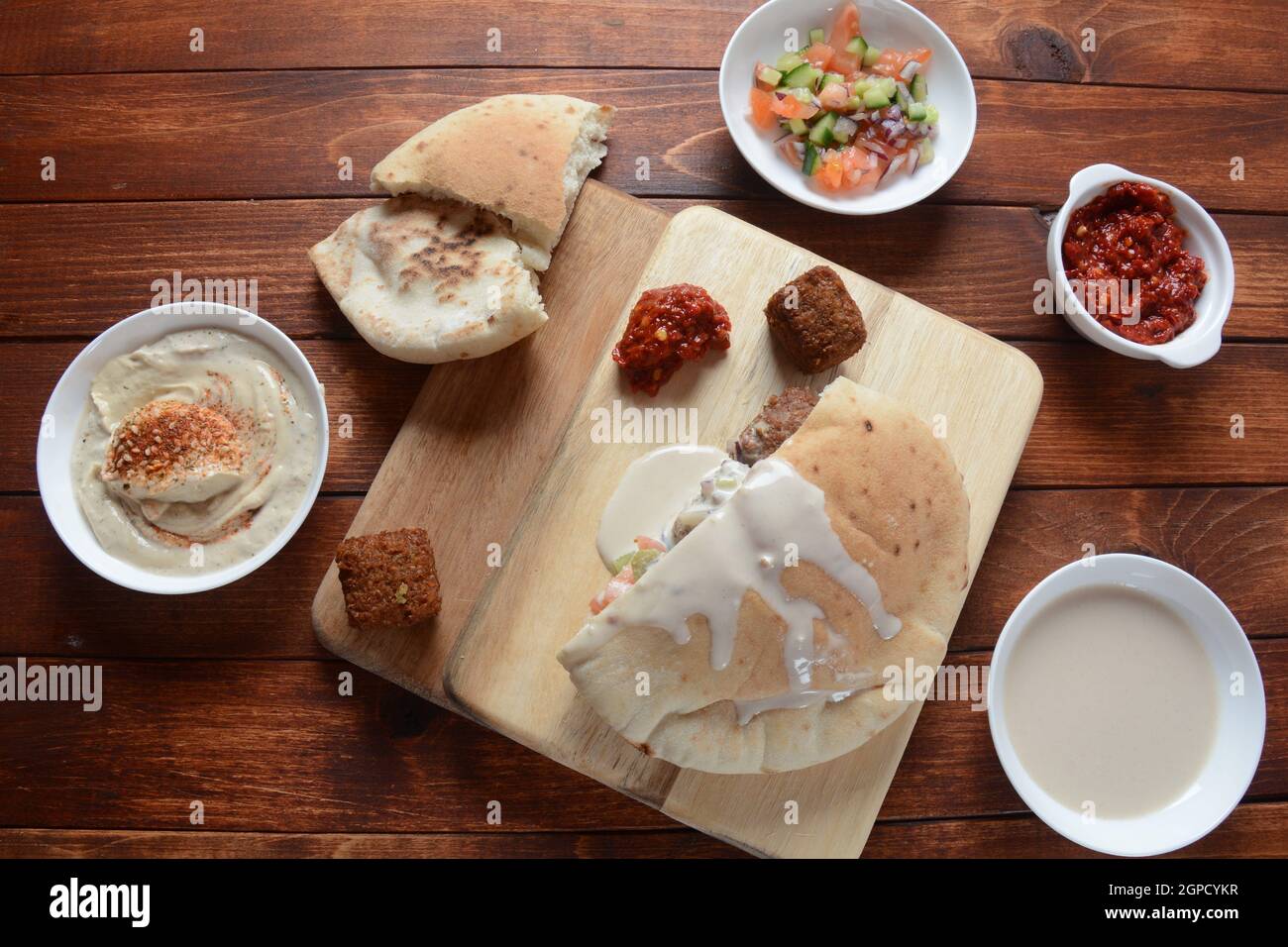 Falafel in pita bread with vegetable salad, harissa sauce, humus ...