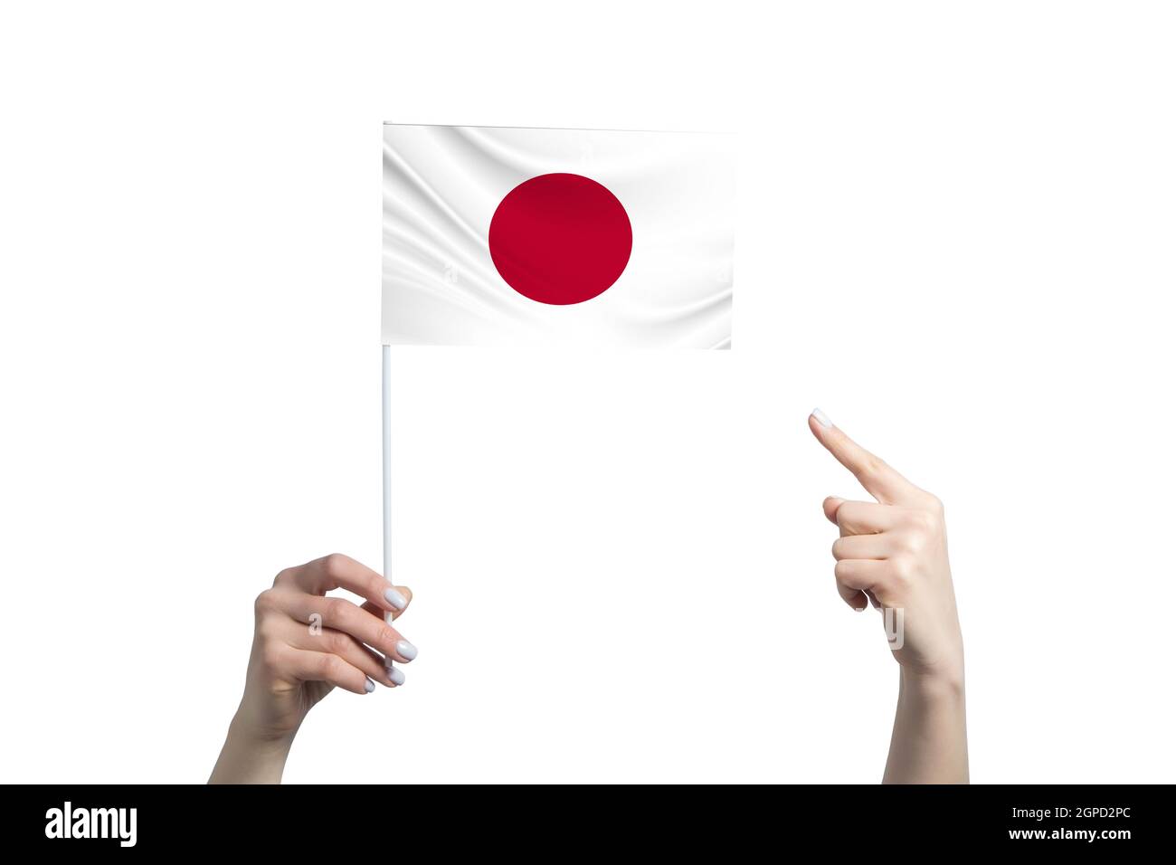 A beautiful female hand holds a Japan flag to which she shows the ...