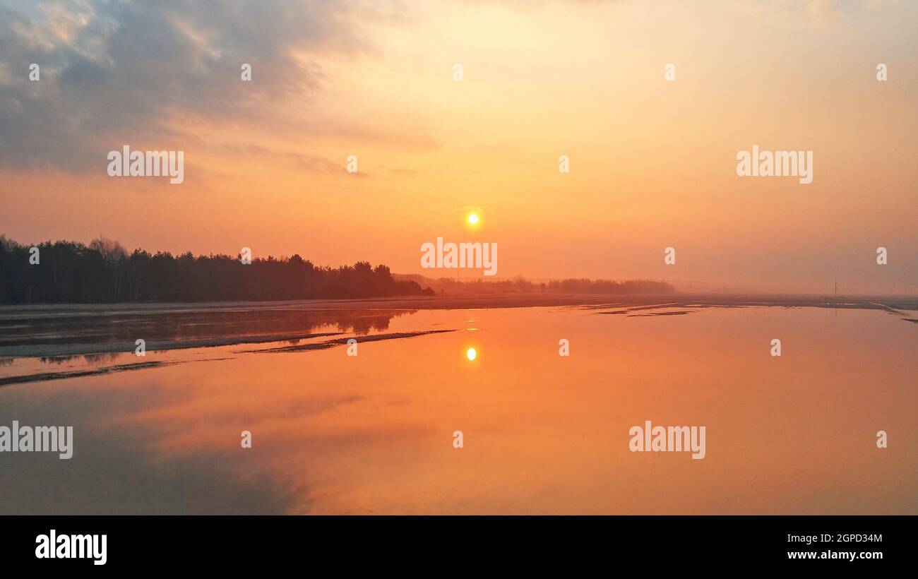 Sunrise spring melting river flood aerial panorama. Overflow water at ...