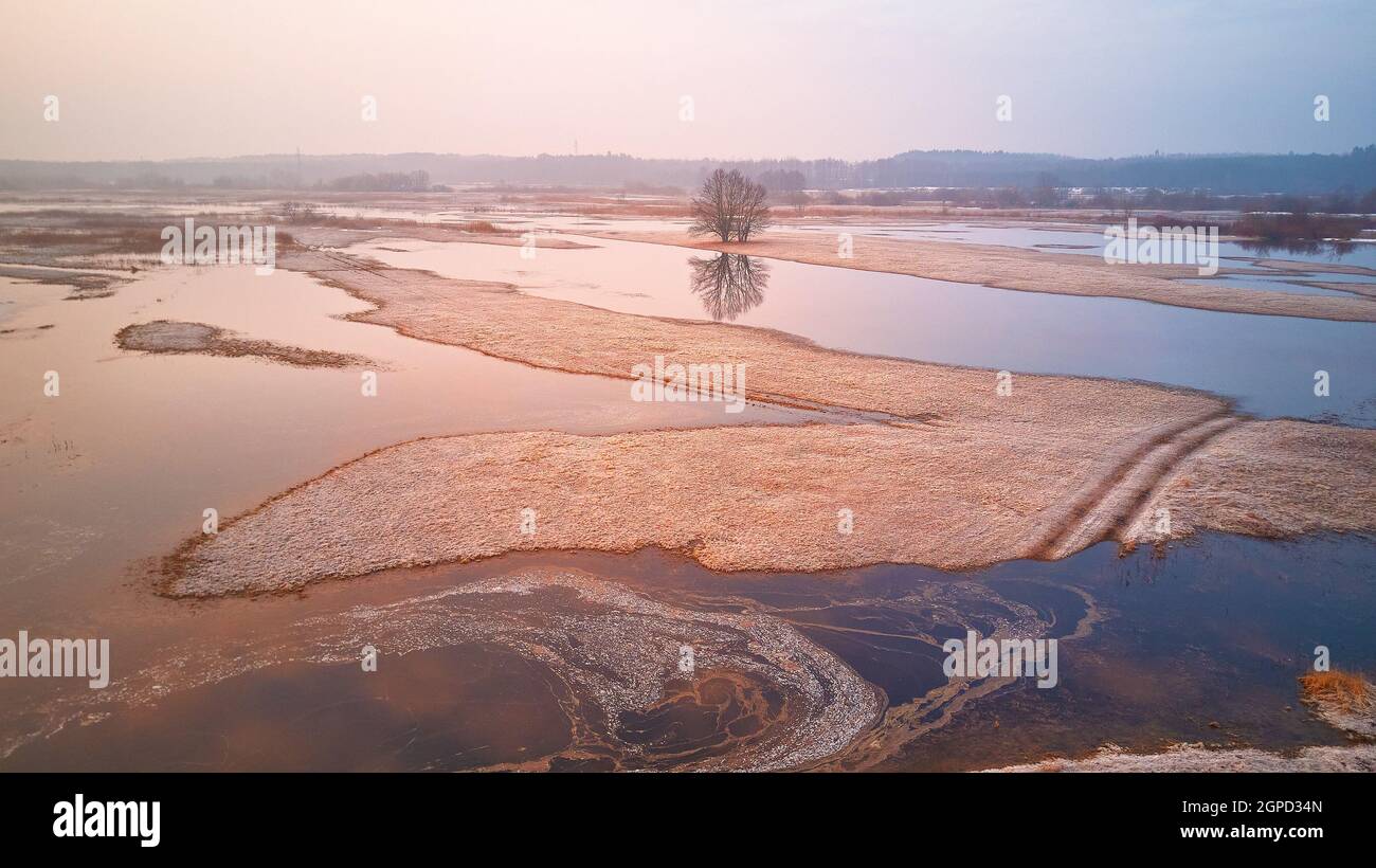 Sunrise spring melting river flood aerial panorama. Overflow water at ...