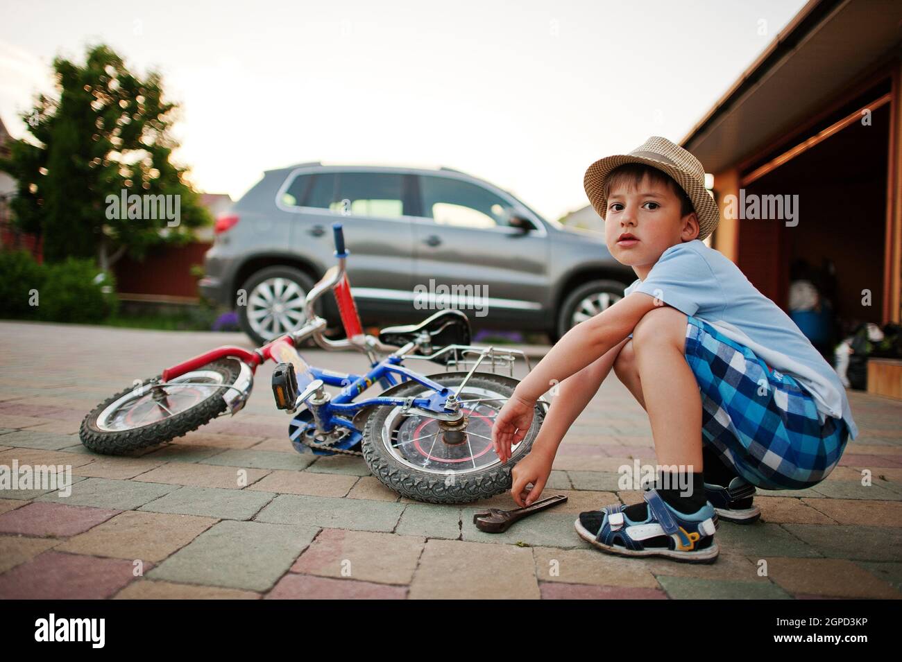 Boy repairing bicycle wheel hi-res stock photography and images - Alamy