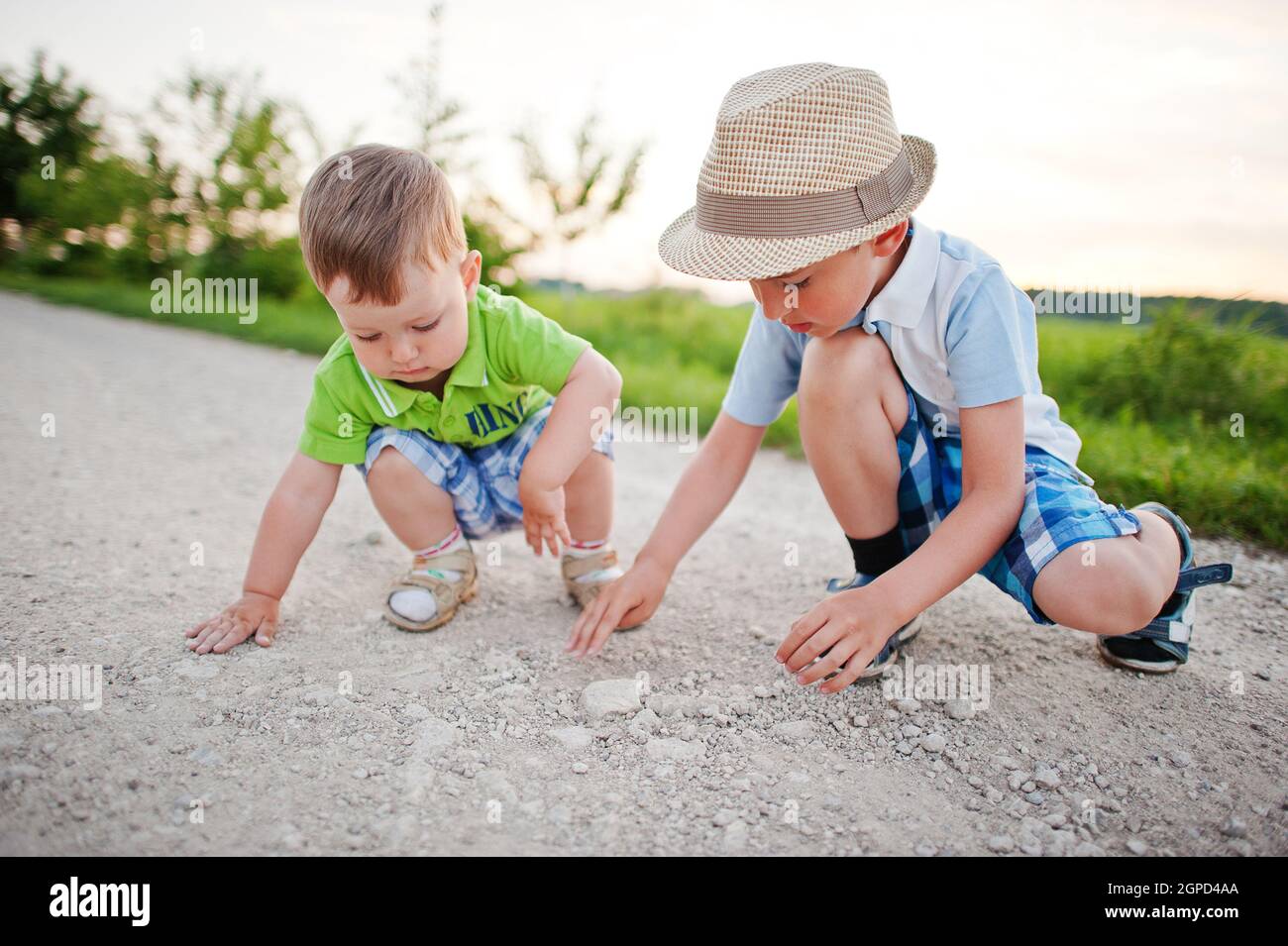 Two brothers playing on village road Stock Photo - Alamy