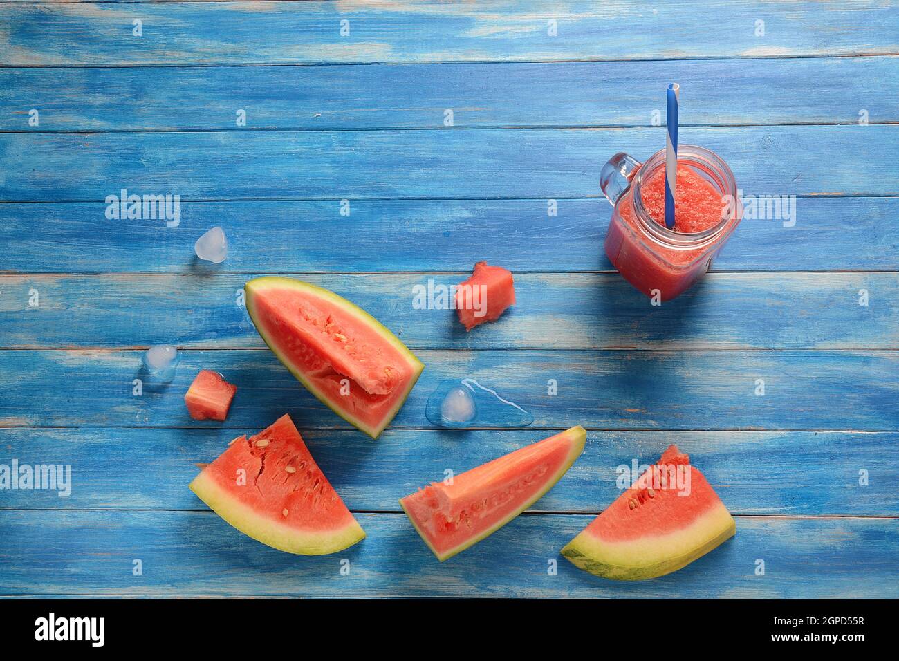 Fresh watermelon cocktail in glass on a blue wooden rustic background ...