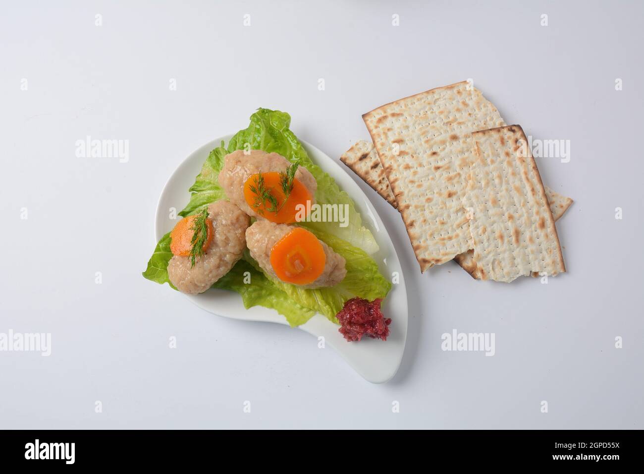 Passover traditional Jewish food- gefilte fish with carrots, lettuce ...