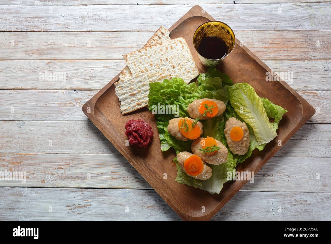 Passover traditional Jewish food- gefilte fish with carrots, lettuce ...