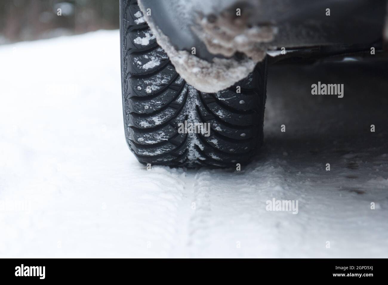 Closeup of car tire in winter on the road covered with snow Stock Photo ...