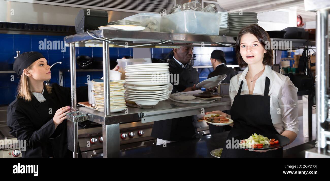 Portrait of happy waiter standing with order Stock Photo - Alamy
