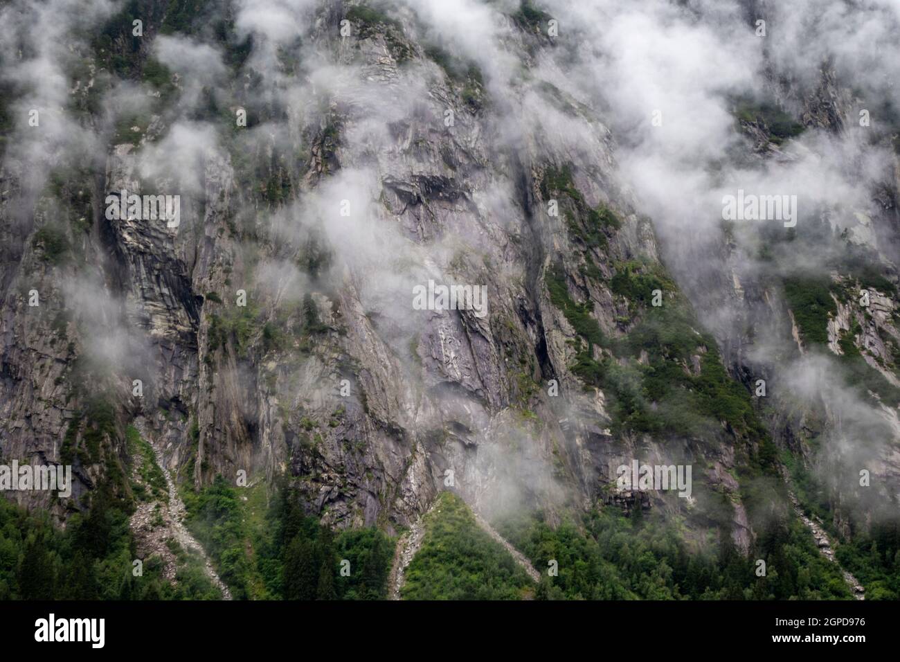 fog rising on a mountain in the alps Stock Photo - Alamy