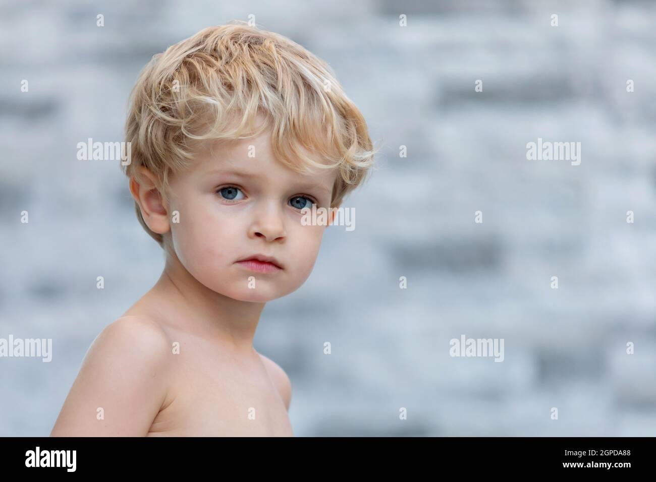 Funny child without t-shirt in the garden Stock Photo - Alamy