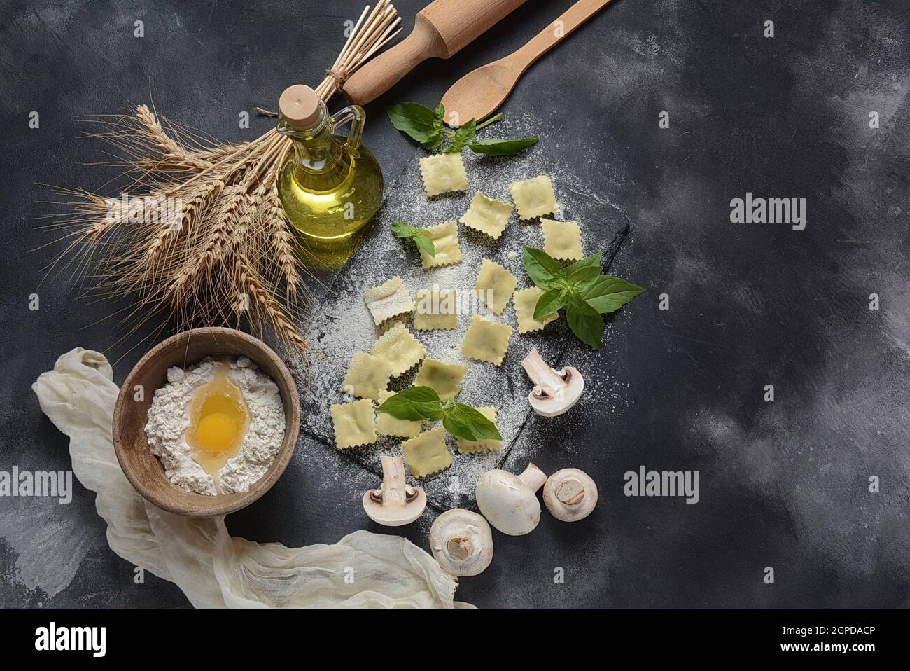 Italian raw ravioli with mushrooms, basil, flour, wheat, olive oil on ...