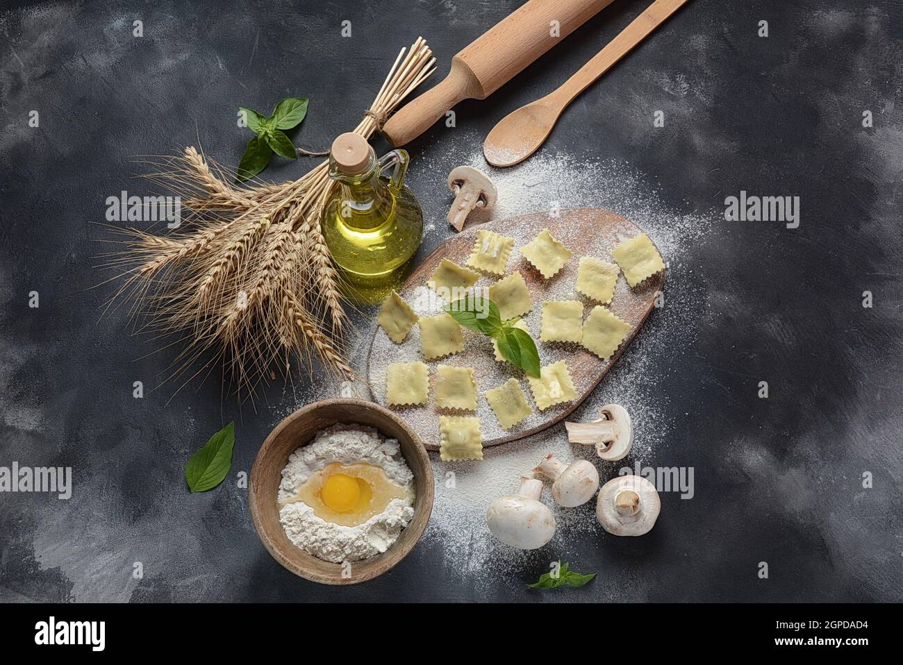 Italian raw ravioli with mushrooms, basil, flour, wheat, olive oil on ...