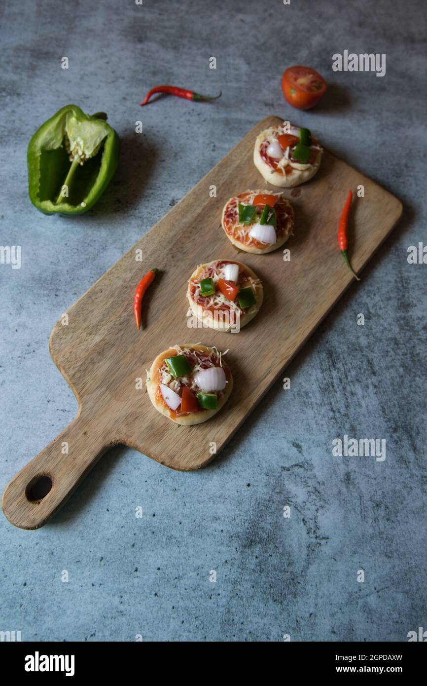 Popular Italian delicacy pizza. Ready to serve pizzas along with ...