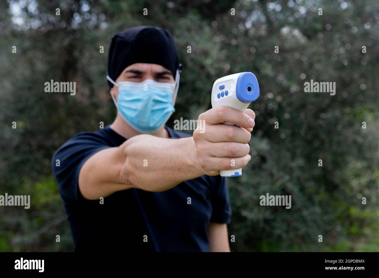 Doctor taking temperature with infrared thermometer Stock Photo - Alamy