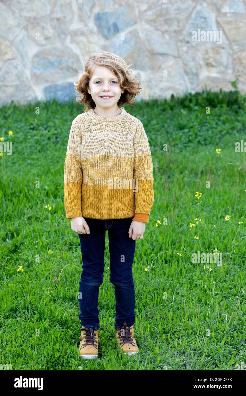 Funny blond kid with long hair Stock Photo - Alamy