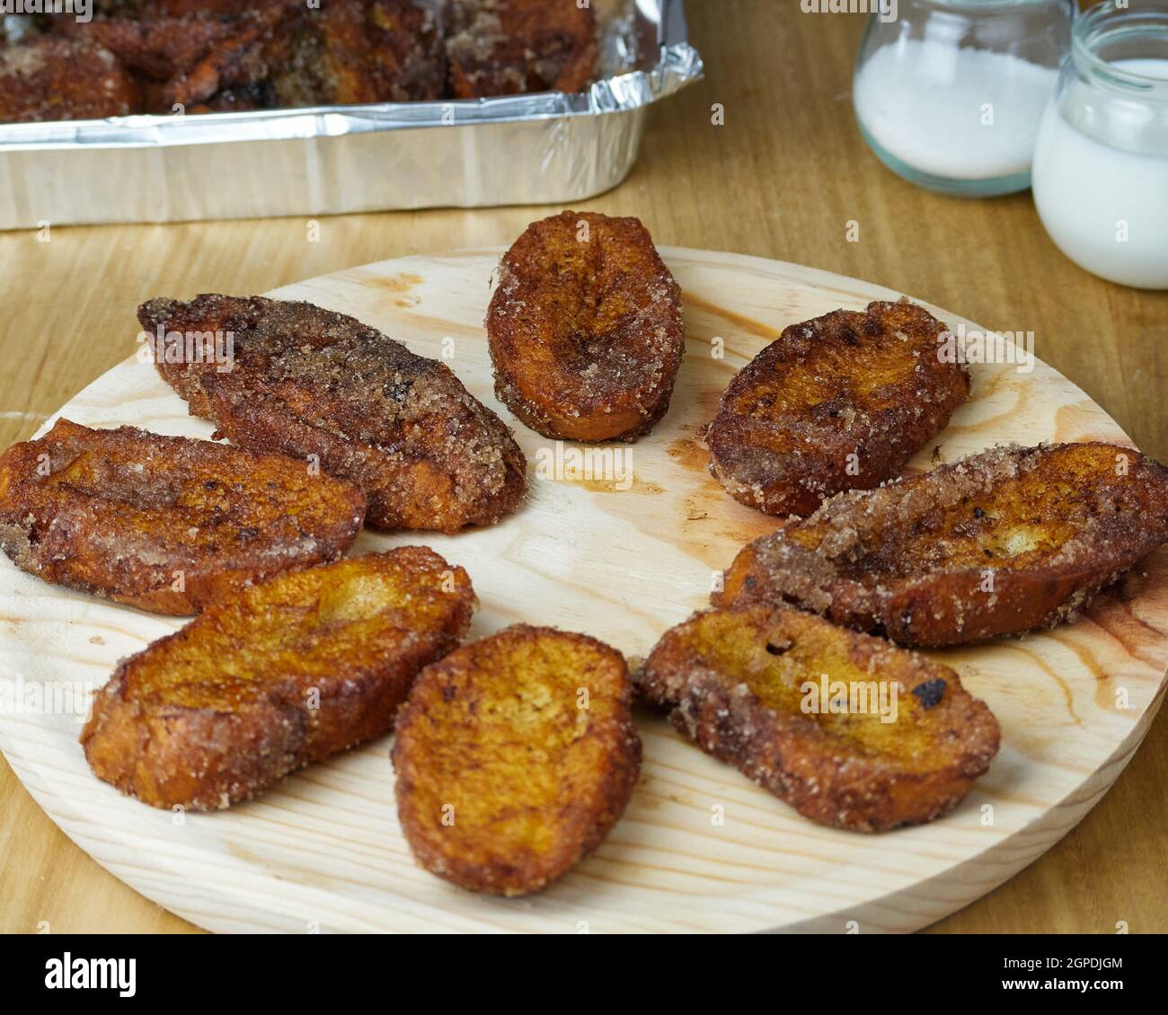 Traditional homemade Spanish Torrijas making a circle on a round wooden ...