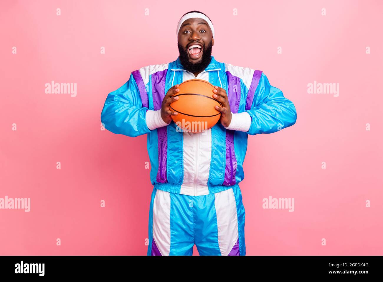 Photo of young african man happy positive smile catch ball play game ...