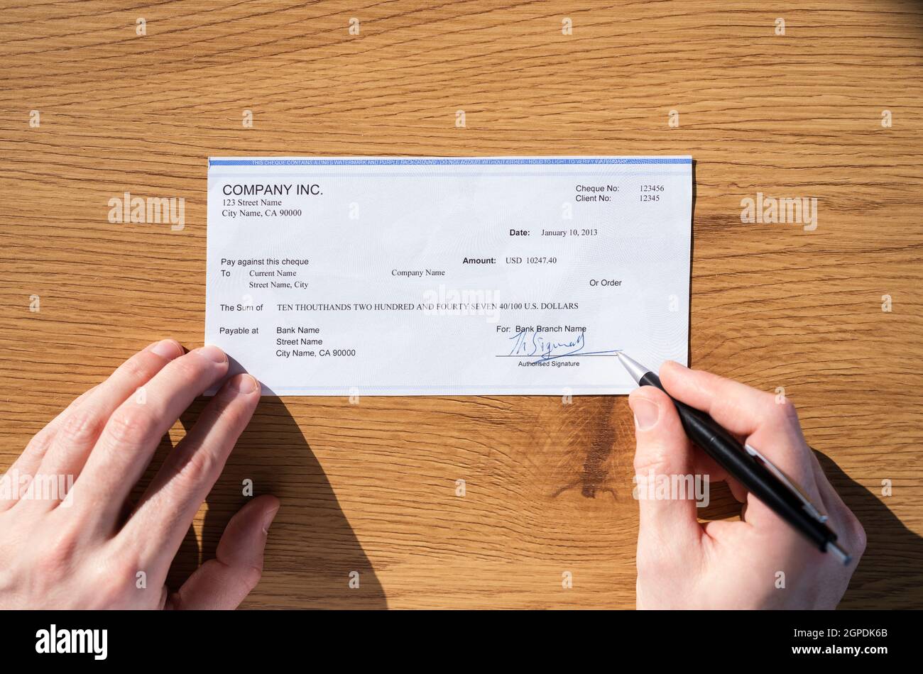Writing Payroll Compensation Check. Bank Pay Cheque Stock Photo - Alamy