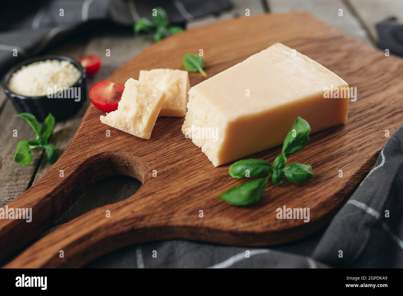 Italian cuisine concept. Cutting board, Parmesan Cheese chunks, grated ...