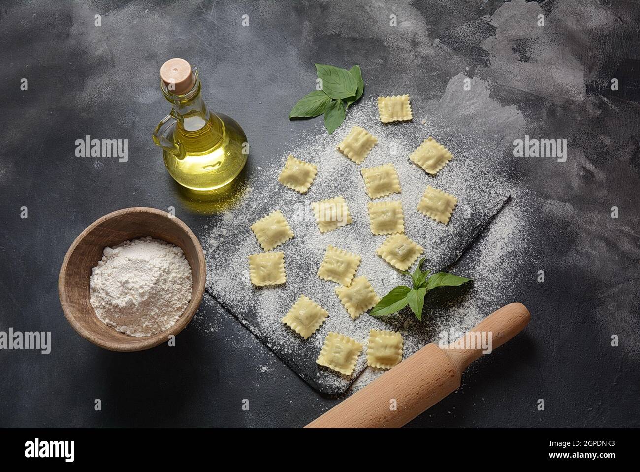 Italian raw ravioli with mushrooms, basil, flour, wheat, olive oil on ...