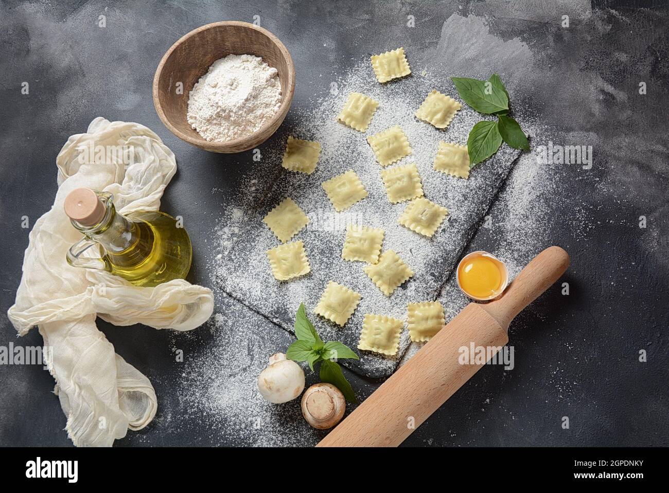 Italian raw ravioli with mushrooms, basil, flour, wheat, olive oil on ...