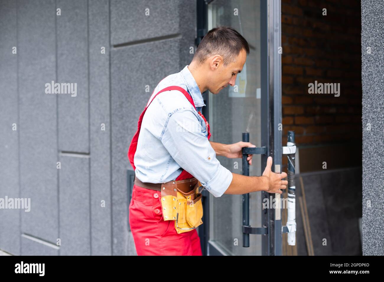 Installation of a lock on the entrance door. Hand 's man with ...