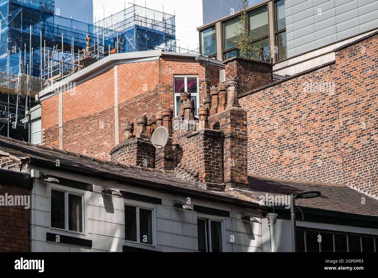 Old chimney stacks and pots on top of traditional ancient houses and ...