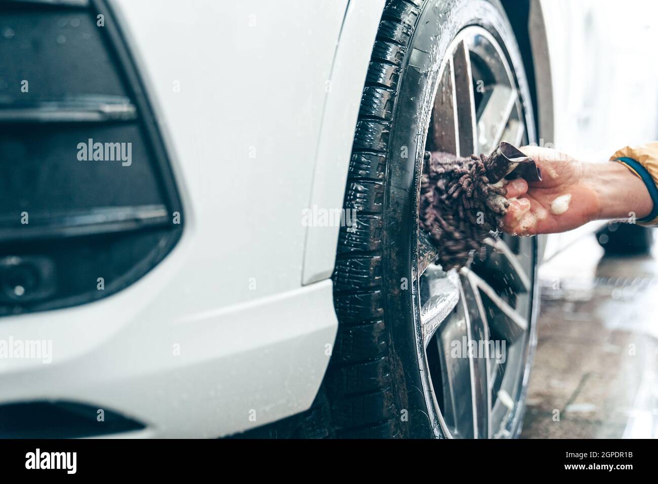 Manual car wheel cleaning with the help of sponges and foam Stock Photo ...